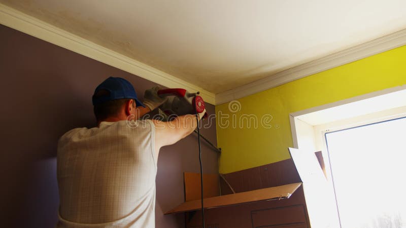 Man Pneumatic Hammer Drill a Hole in the Wall. a Worker Using an ...
