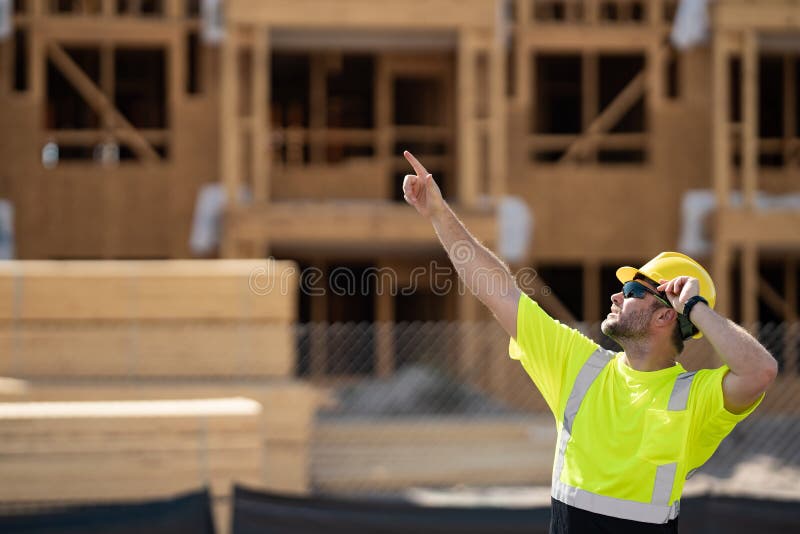 Worker Pointing Out. Construction Worker in Helmet at Building ...