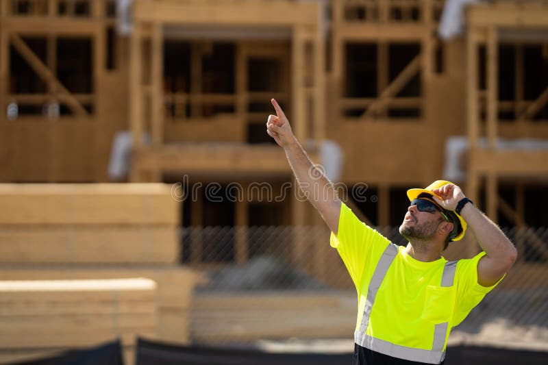 Worker Pointing Out. Construction Worker with Hardhat Helmet on ...