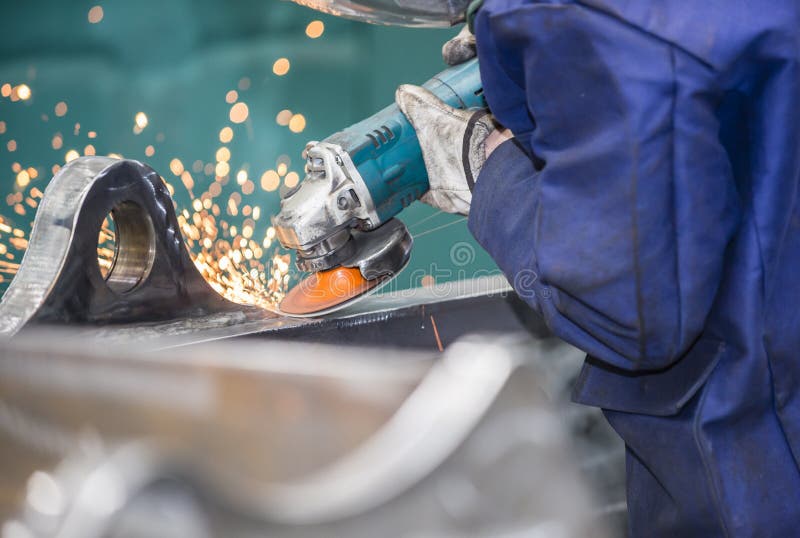Worker Polishes Part of the Steel Construction - Zoom. Stock Image ...