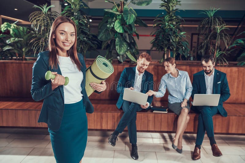 Worker Posing Exercising with Dumbbells in Office. Stock Image - Image ...