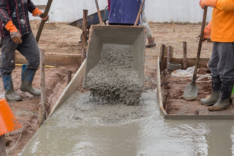 Worker Pouring Cement from Cart To Floor Stock Image - Image of paving ...