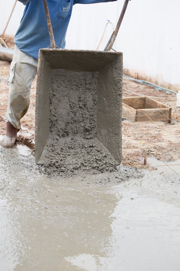Worker Pouring Cement from Cart To Floor Stock Image - Image of ...