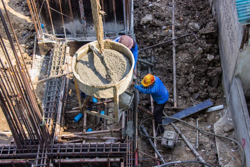 Worker Pouring Cement Pouring into Foundations Formwork at Building ...