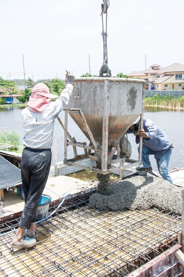 Worker Pouring Concrete Works at Construction Site Stock Photo - Image ...