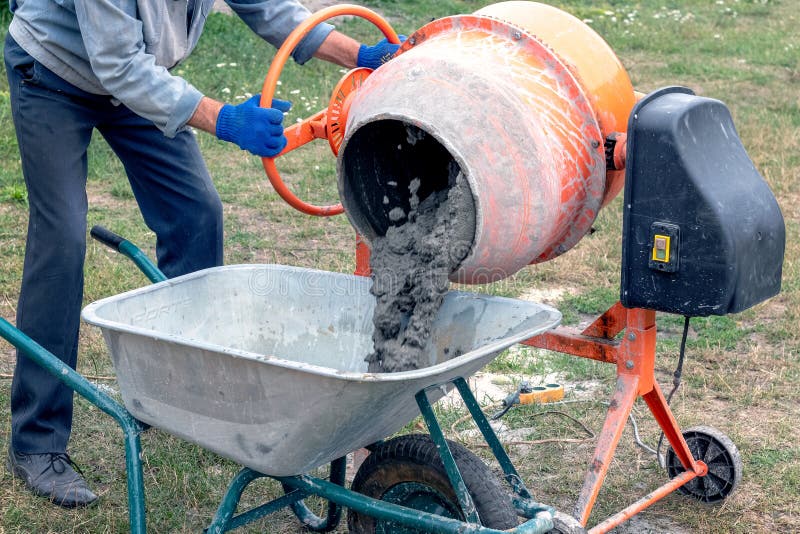 A Worker Pours Cement Mortar, Concrete, from a Concrete Mixer into a ...