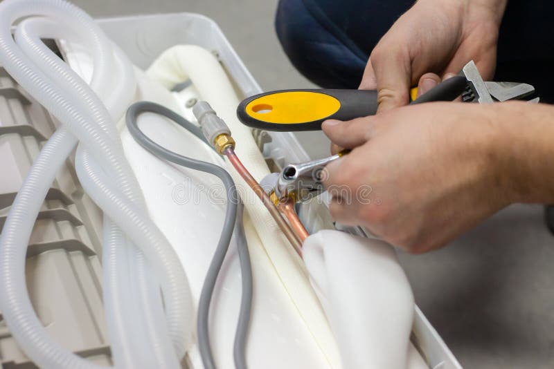 The Worker is Preparing To Install the Air Conditioner. Tools for ...