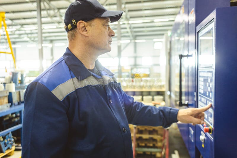 A Worker Presses a Button and Starts an Automatic Manufacturing Process ...
