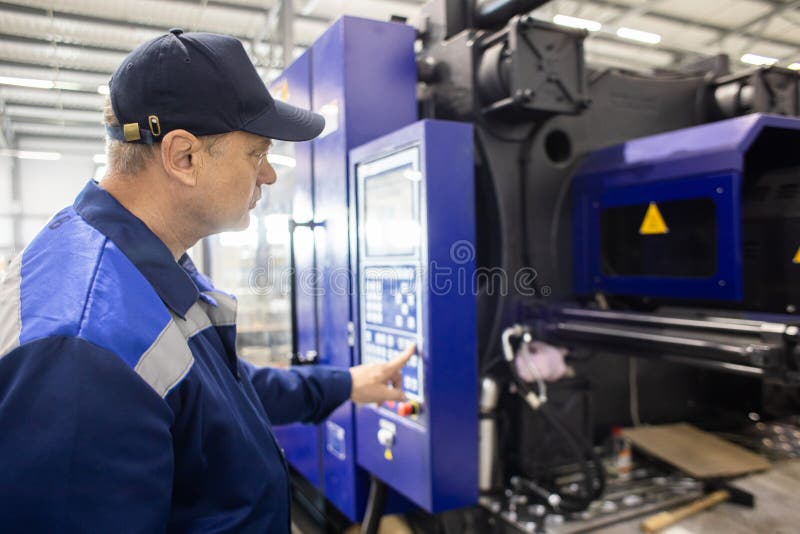 A Worker Presses a Button and Starts an Automatic Manufacturing Process ...
