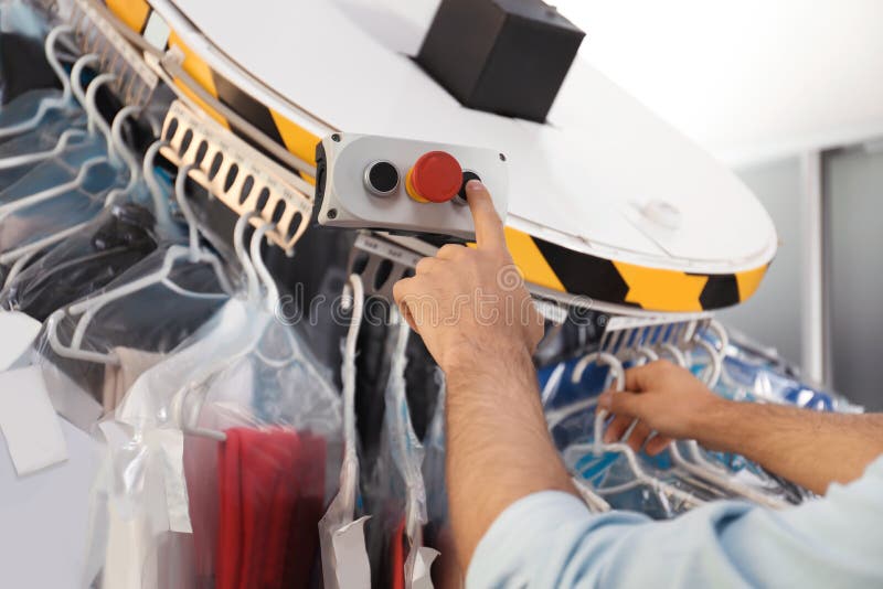 Worker Pressing Button on Control Panel of Garment Conveyor at Dry ...