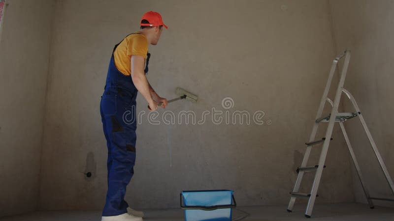 Worker Priming Interior Walls Using a Paint Roller in a Residential ...
