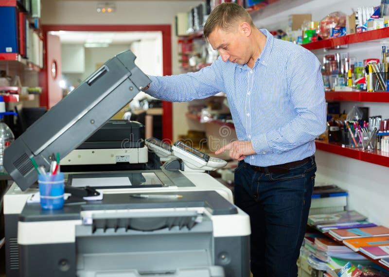Worker in Printing and Press Centar Uses a Magnifying Glass Stock Photo ...
