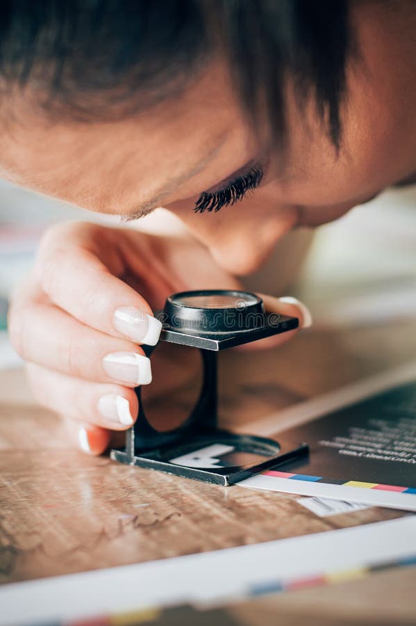 Worker in Printing and Press Centar Uses a Magnifying Glass Stock Photo ...