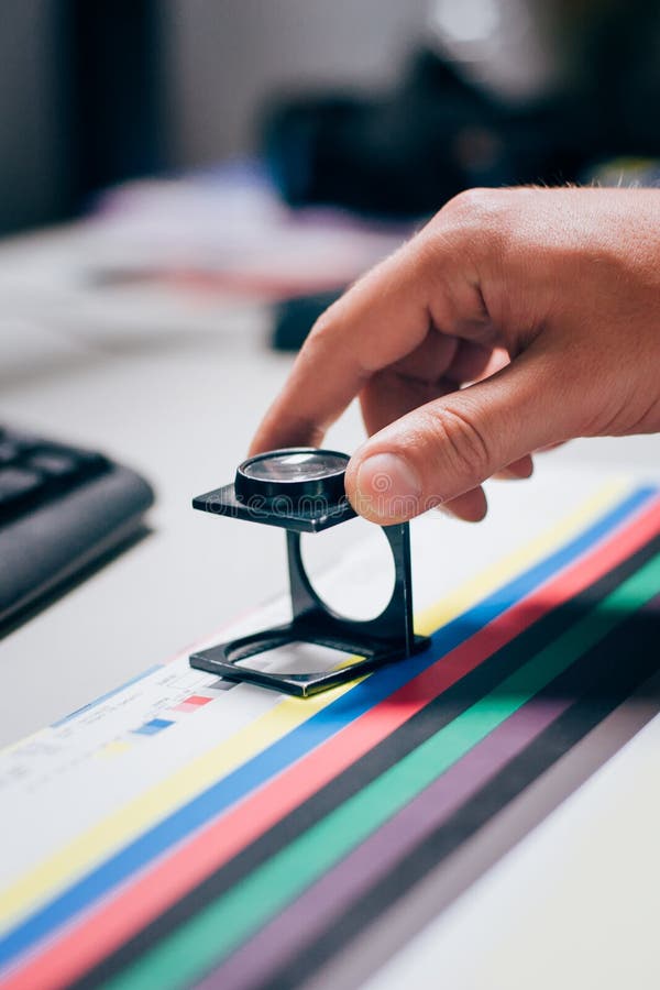 Worker in Printing and Press Centar Uses a Magnifying Glass Stock Photo ...