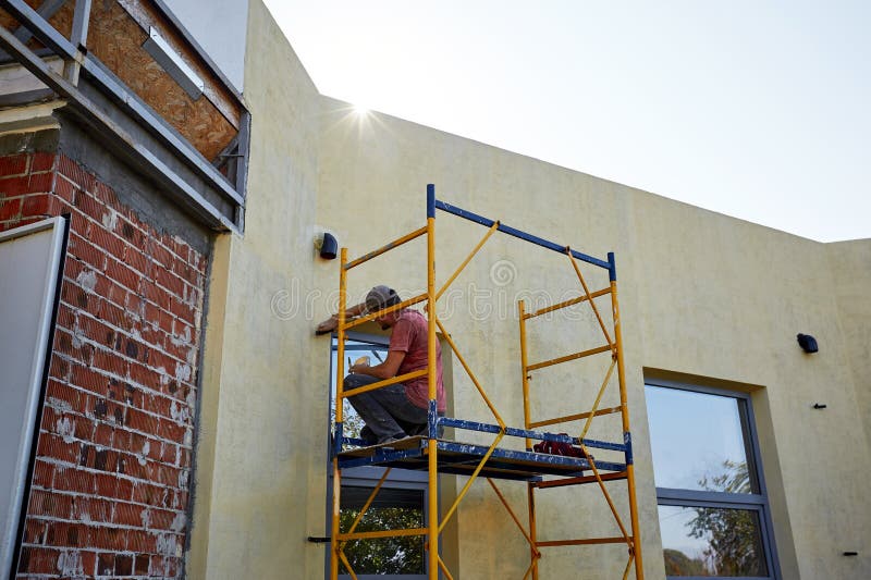 Builder at the Finish House Working with the Tool. Stock Image - Image ...