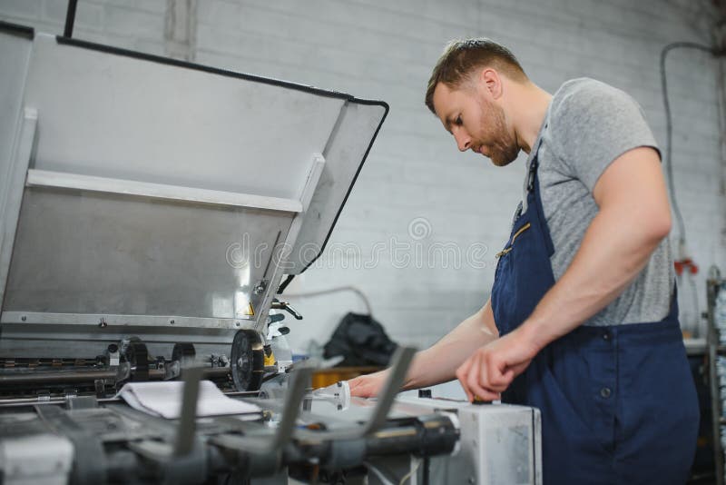 Worker in Protective Clothing in Factory Using Machine Stock Photo ...