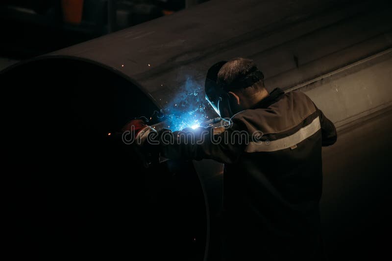 Worker in Protective Mask Welding Pipe in Factory Stock Photo - Image ...