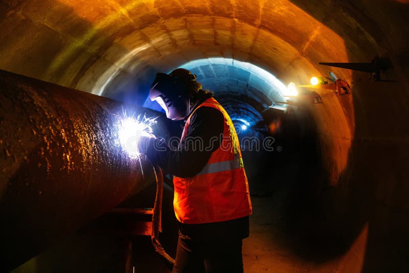 Worker in Protective Mask Welding Pipe in Tunnel Stock Photo - Image of ...