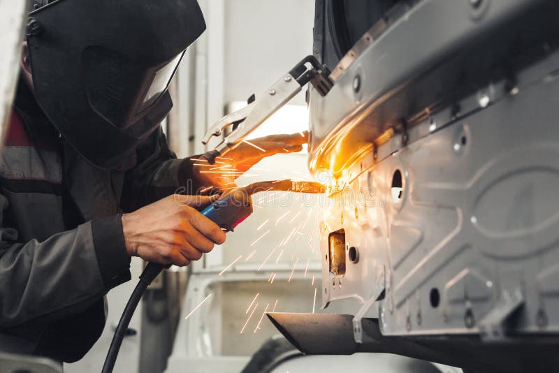 Metal Working Car Body with Carbon Dioxide Welding Machine. Repair of ...