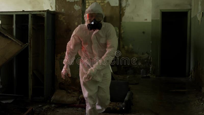 Worker in Protective Suit Inside the Ruined Building Jumping from the ...