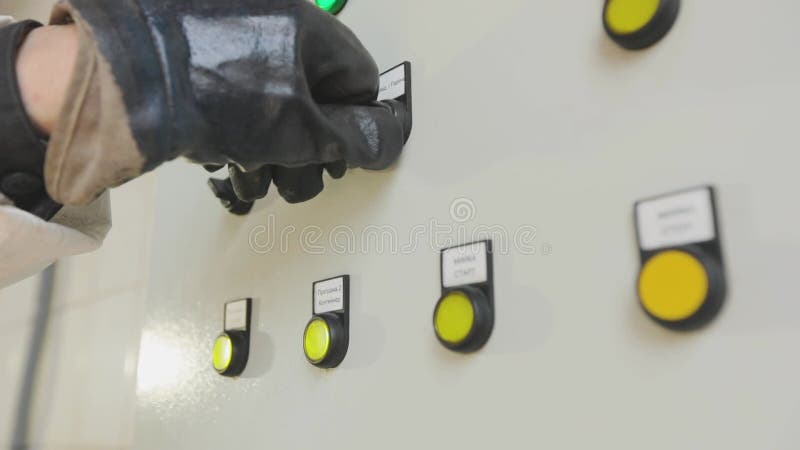 A Worker in a Protective Suit Presses Buttons on the Control Panel. a ...