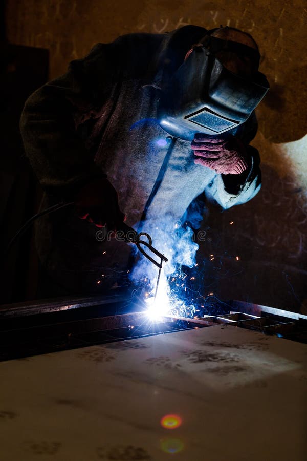 Worker in Protective Uniform and Mask Welding Metal. Stock Photo ...