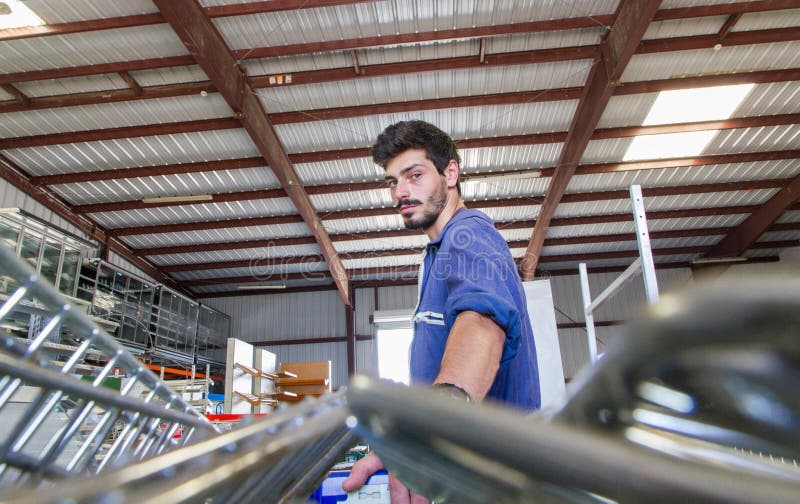 Worker Pulling Cart in Warehouse Stock Photo - Image of metal ...
