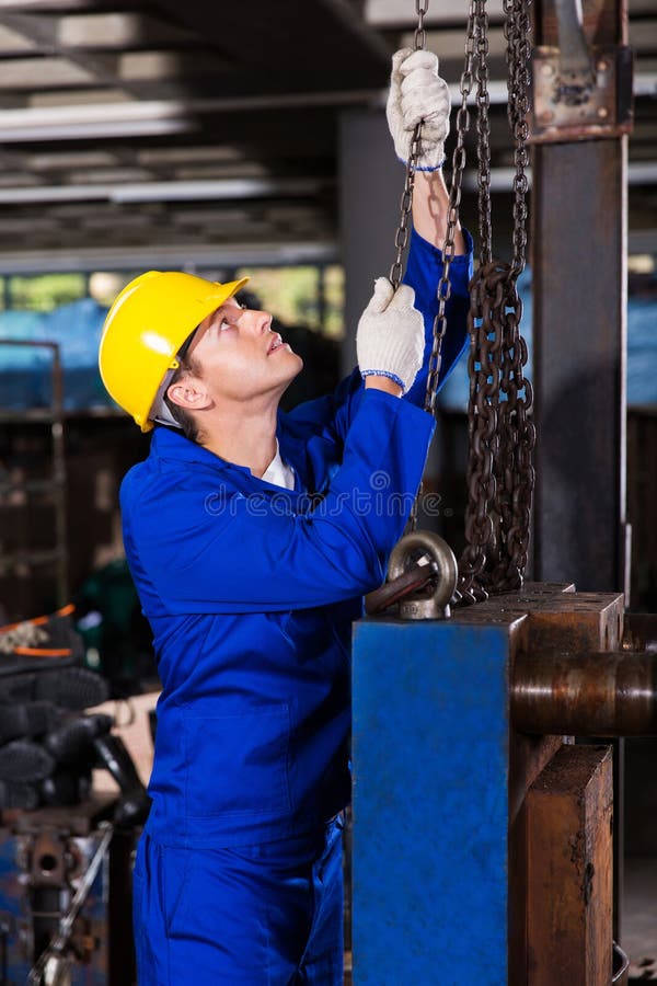 Worker pulling chains stock image. Image of helmet, modern - 45402391