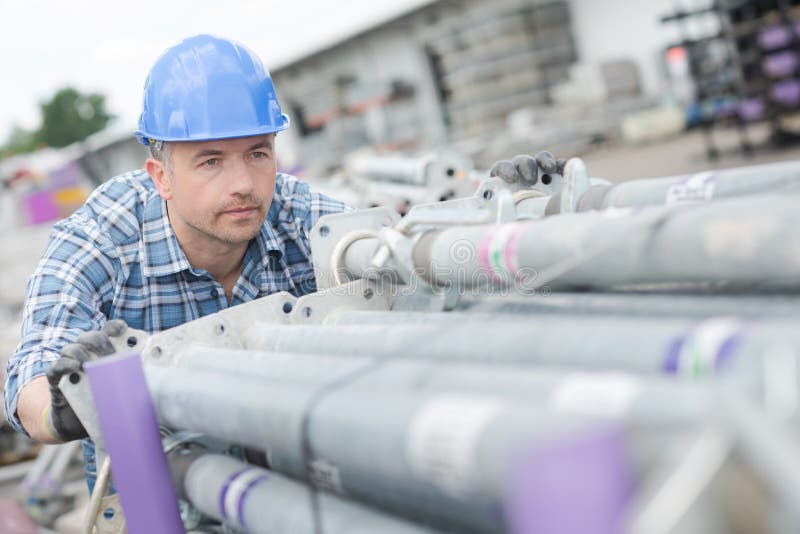 Worker Pushing Stack Scaffolding Tubes Stock Photo - Image of toil ...