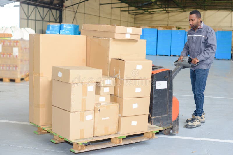 Man Pushing Stack Moving Boxes on Hand Truck Stock Image - Image of ...