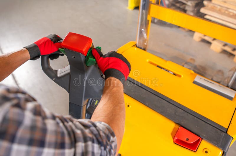 Worker Pushing Yellow Forklift in Warehouse Stock Photo - Image of ...