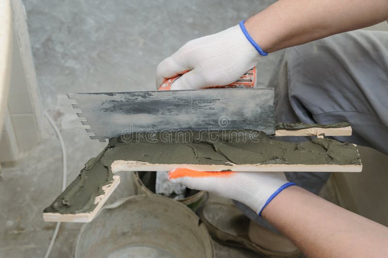 Worker Putting Tiles on the Wall in the Kitchen. Stock Photo - Image of ...