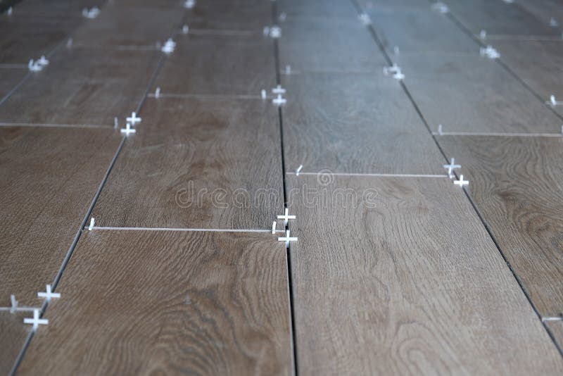 The Worker Puts Ceramic Tiles on the Construction Site Stock Photo ...