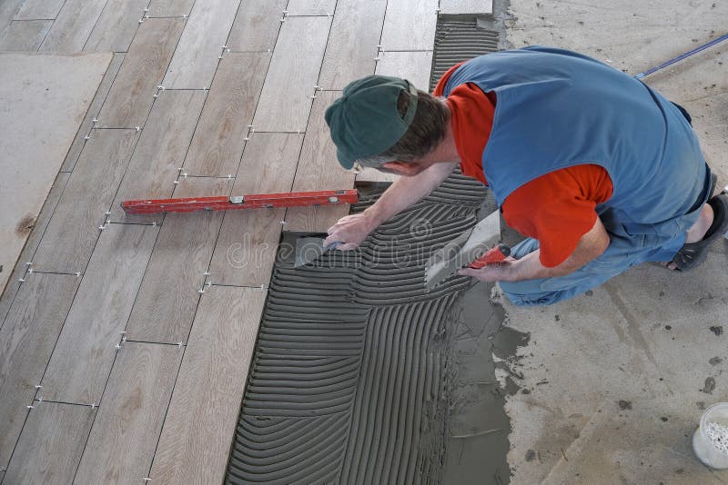 The Worker Puts Ceramic Tiles on the Construction Site Stock Image ...