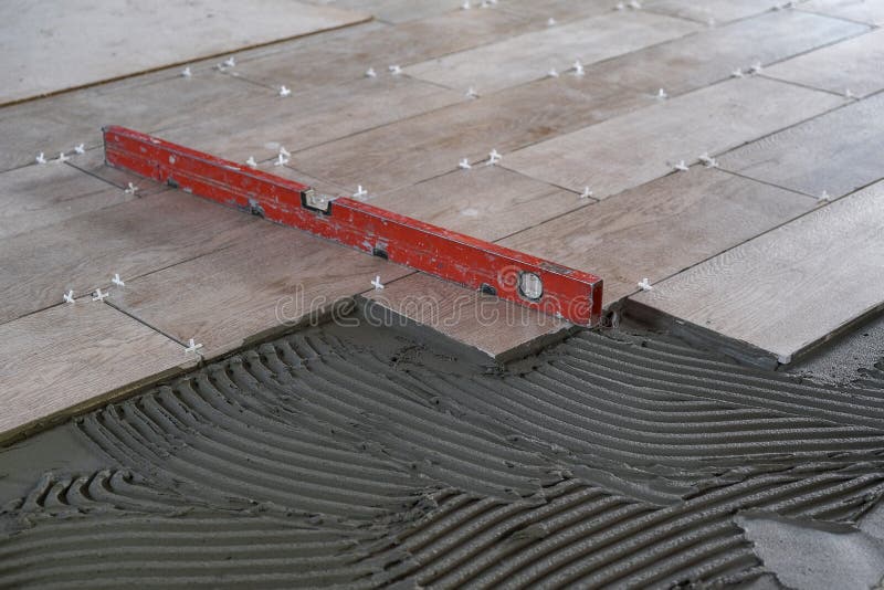The Worker Puts Ceramic Tiles on the Construction Site Stock Photo ...