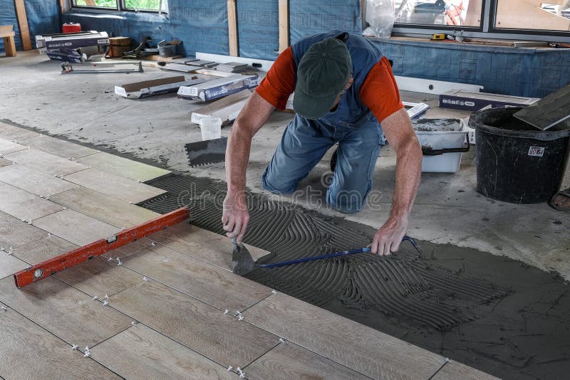 The Worker Puts Ceramic Tiles on the Construction Site Stock Image ...