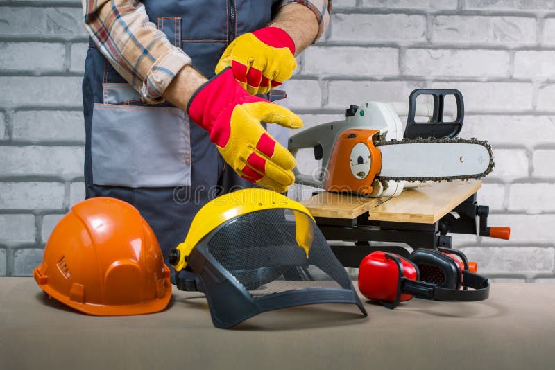 Worker Puts Protective Gloves in Workshop. Stock Image - Image of ...