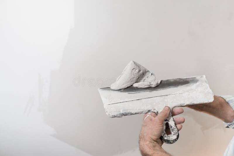 A Worker Puts Putty on a Spatula for Plastering Walls Stock Image ...