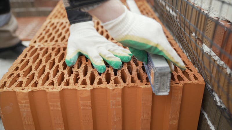 Porous Ceramic Blocks Texture Background. Worker Puts a Red Ceramic ...