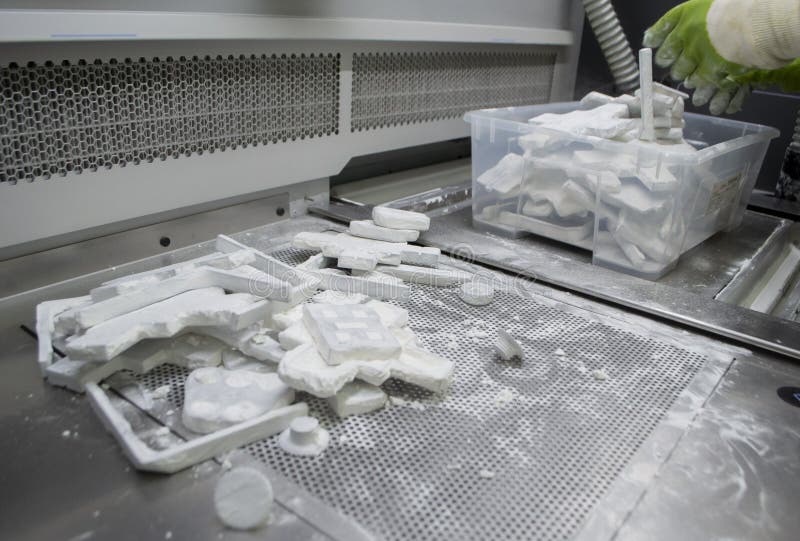 Worker Putting into Box Models Printed on 3D Printer and Covered White ...