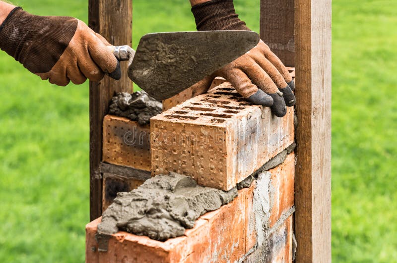 A Worker is Laying a Brick Wall Stock Image - Image of laying, concrete ...