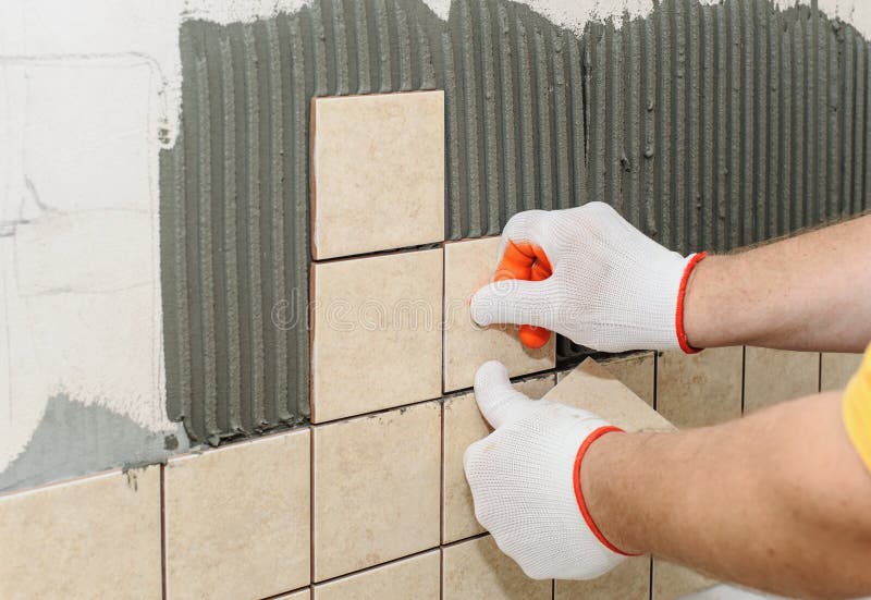 Worker Putting Tiles on the Wall in the Kitchen. Stock Photo - Image of ...
