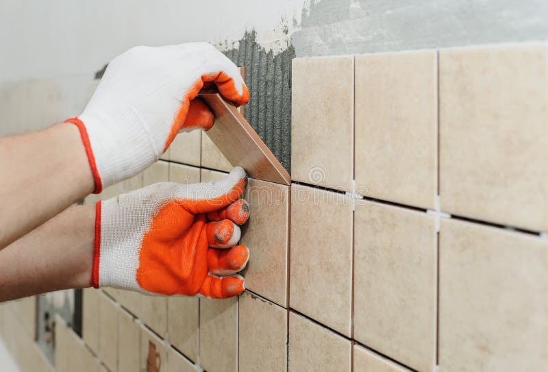 Worker Putting Tiles on the Wall in the Kitchen. Stock Photo - Image of ...