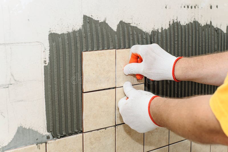 Worker Putting Tiles on the Wall in the Kitchen. Stock Photo - Image of ...