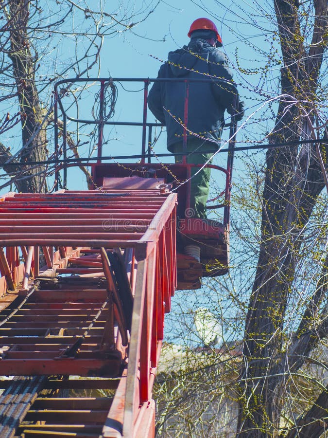 Worker on the Red Lift Machine Stock Photo - Image of industrial, cable ...