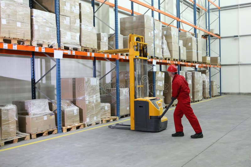 Worker in Red Uniform at Work in Warehouse Stock Photo - Image of ...