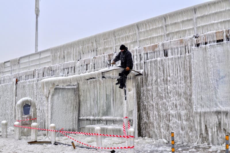 Worker Removes Ice from Frosted Bus Stop Editorial Photo - Image of ...