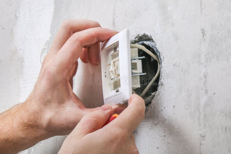 A Worker Removes Light Switch for Wallpapering. Stock Image - Image of ...