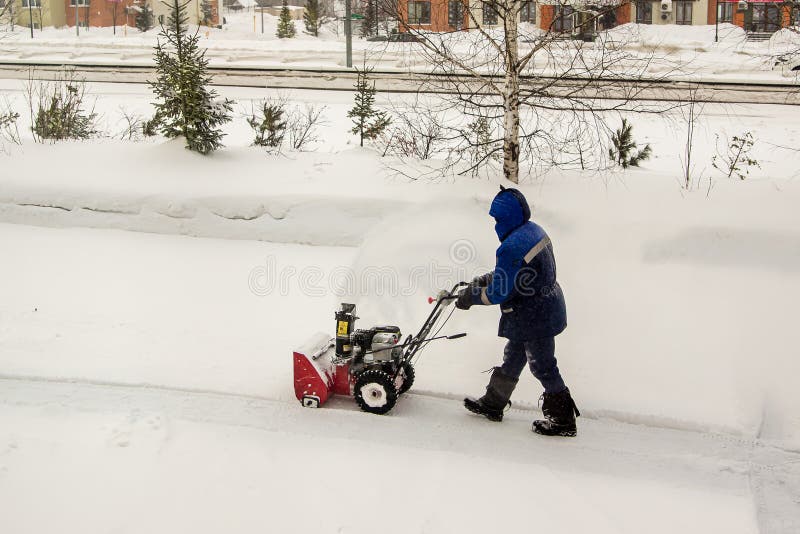 Worker Removes Snow from the Yard Using a Snowplow Stock Photo - Image ...