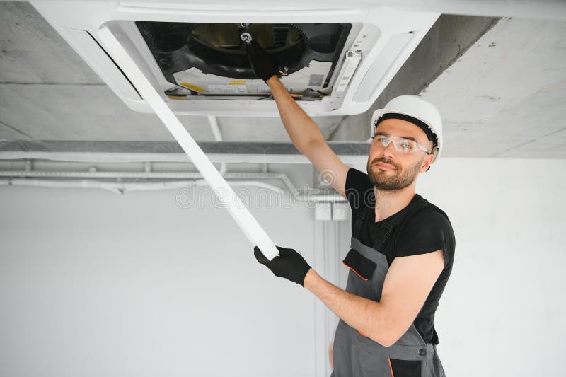 Worker Repairing Ceiling Air Conditioning Unit Stock Image - Image of ...